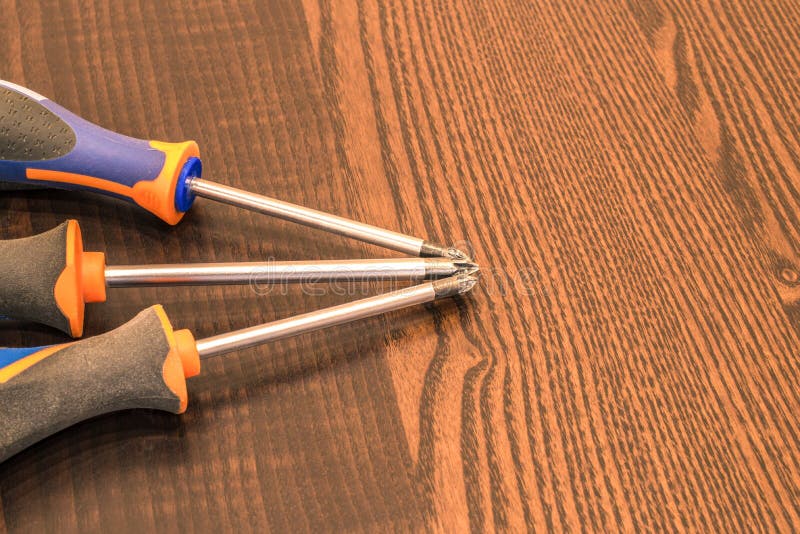 Three Screwdrivers on the Brown Table Stock Image - Image of brown ...