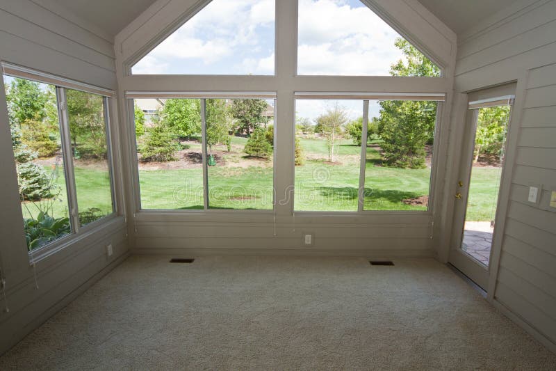 Three Season Room with Large Window Overlooking Lush Backyard in Fort ...