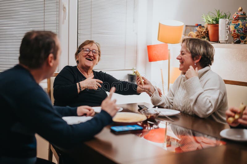 Three Seniors Enjoying a Lively Conversation during a Meal Stock Photo ...