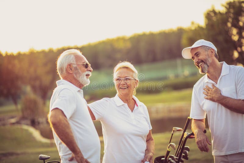 Seniors Golfers Talking on Golf Field Stock Photo - Image of cheerful ...