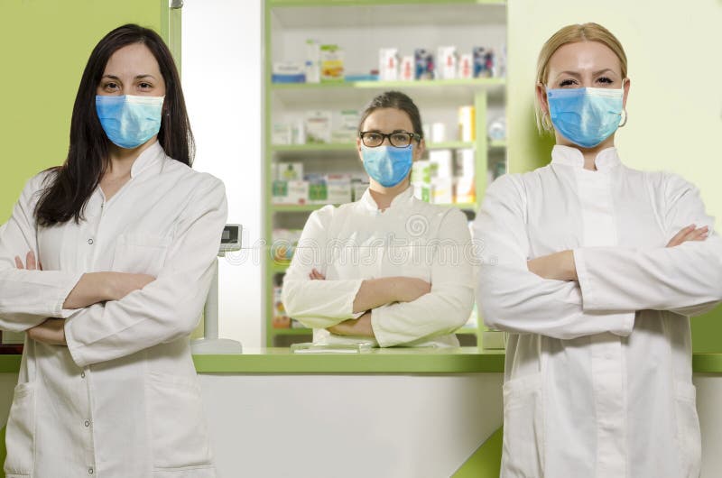 Three Serious Female Pharmacists with Protective Clothes Stock Image ...