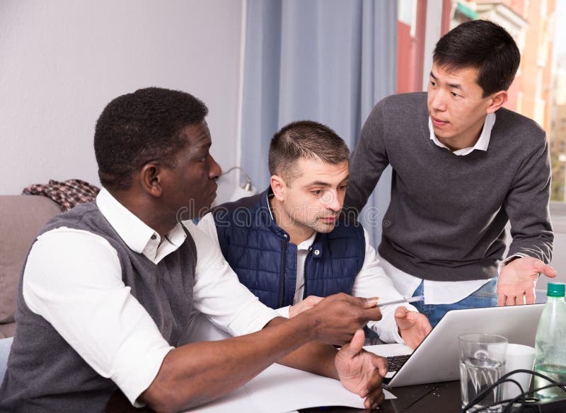 Three Seriouse Men are Working with Project on Laptop Together Stock ...