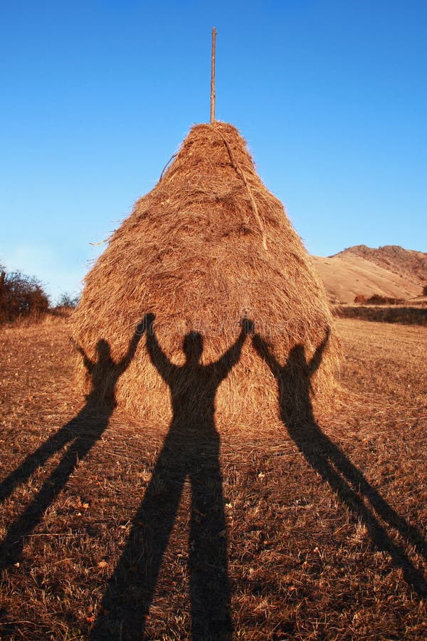 Three Shadows Holding Hands on Haystack Stock Image - Image of ...
