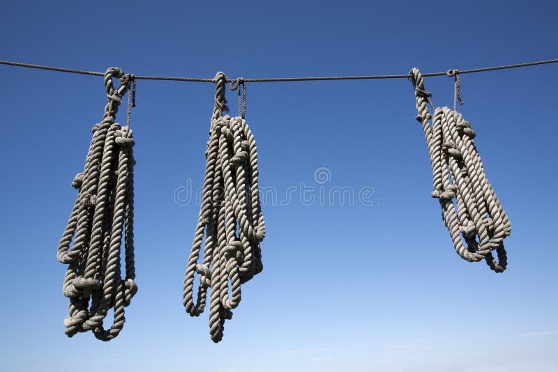 Three Ships Ropes Hanging Off of Rope Stock Photo - Image of grey ...