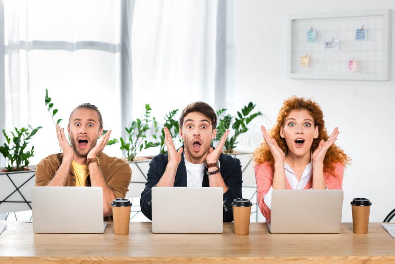 Three Shocked Friends Sitting at Table Stock Image - Image of shocked ...