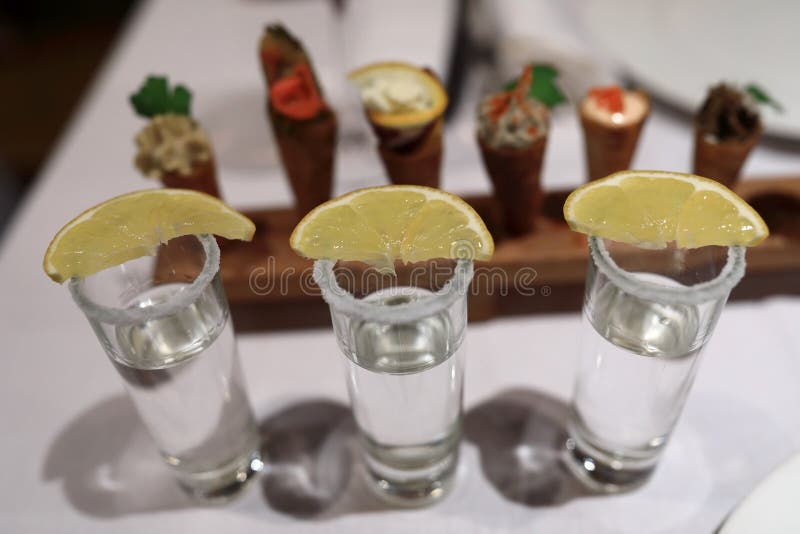 Three shots of tequila stock photo. Image of citrus - 139626376
