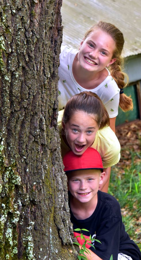 Surprise from Behind Tree stock photo. Image of leaning - 194430998