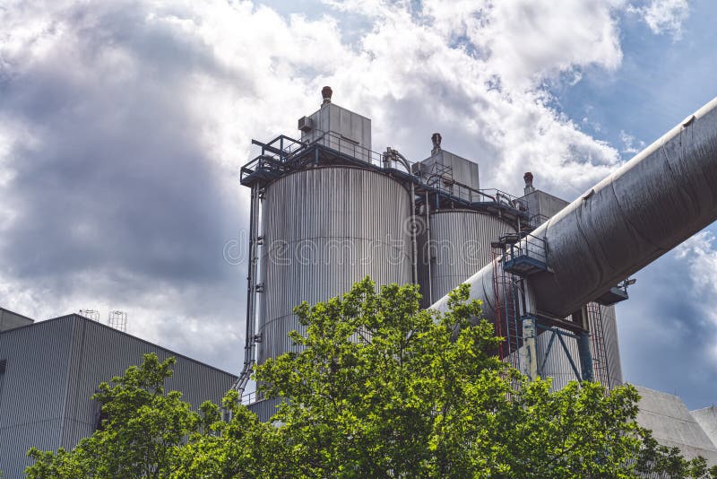 Three Silos and a Large Pipe of a Factory Stock Image - Image of ...
