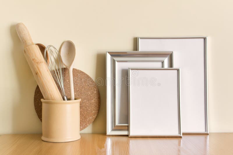 Three Silver Frames and Wooden Kitchen Utensils Stock Image - Image of ...