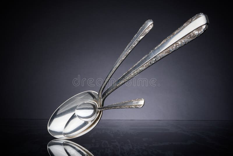 Three Silver Spoons in Balance Stock Image - Image of togetherness ...
