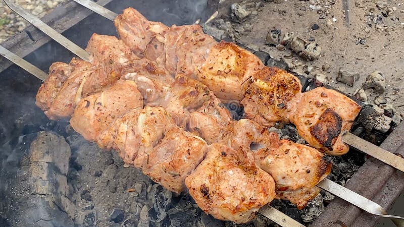 Three Skewers with Meat are Grilled on Coals. Cooking Barbecue Stock ... Three Skewers with Meat are Grilled on Coals. Cooking Barbecue Stock ...
