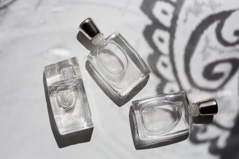 Three Small Bottles of Perfume in Grey Stock Image - Image of ...