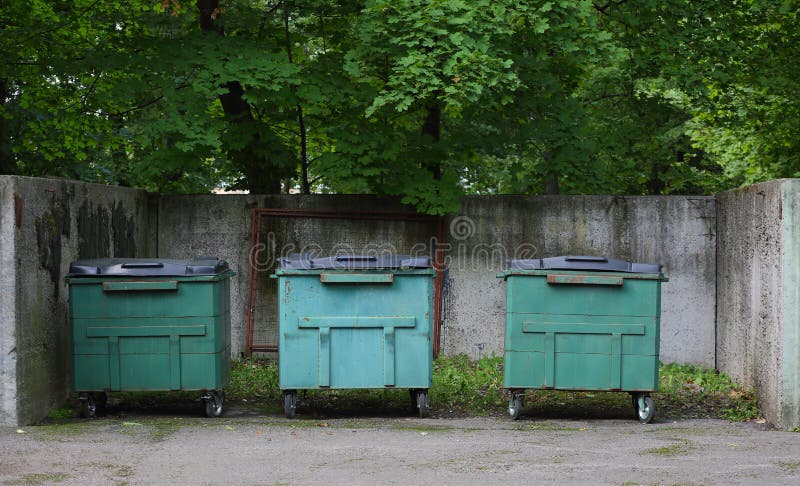 Three Small Green Plastic Mobile Garbage Containers on the Street Stock ...