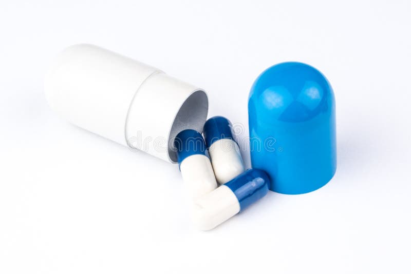 Three Small Pills Are Coming Out From Big Blue And White Capsule Stock