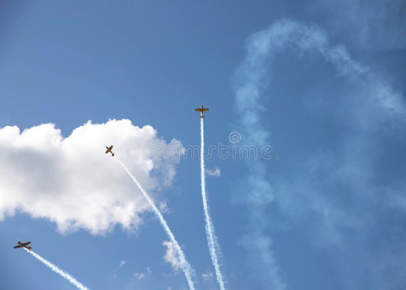 Three Small Planes are Flying in Different Directions Across the Sky ...
