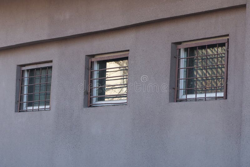 Three Small Square Windows on a Brown Concrete Wall Stock Photo - Image ...