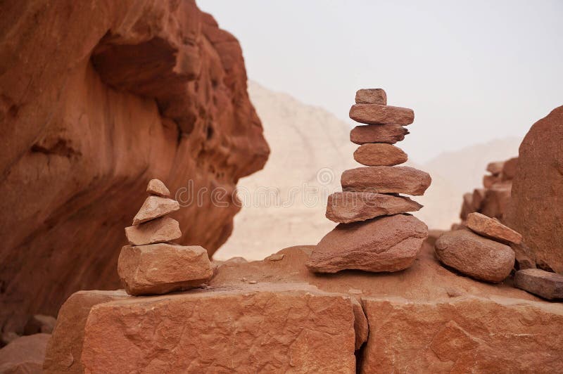 Balanced Stack of Rocks in the Desert with Mountains on the Background ...