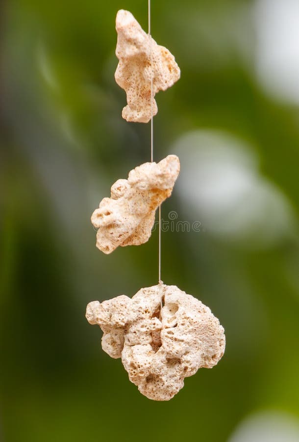 Three Small White Rocks Hanging from a String Stock Image - Image of ...