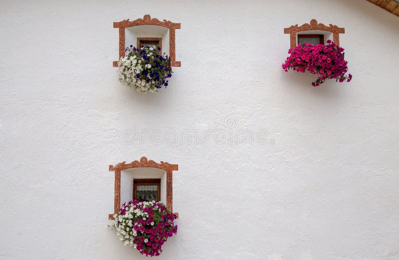 Three Small Windows Decorated with Flowers with a White Facade Stock ...