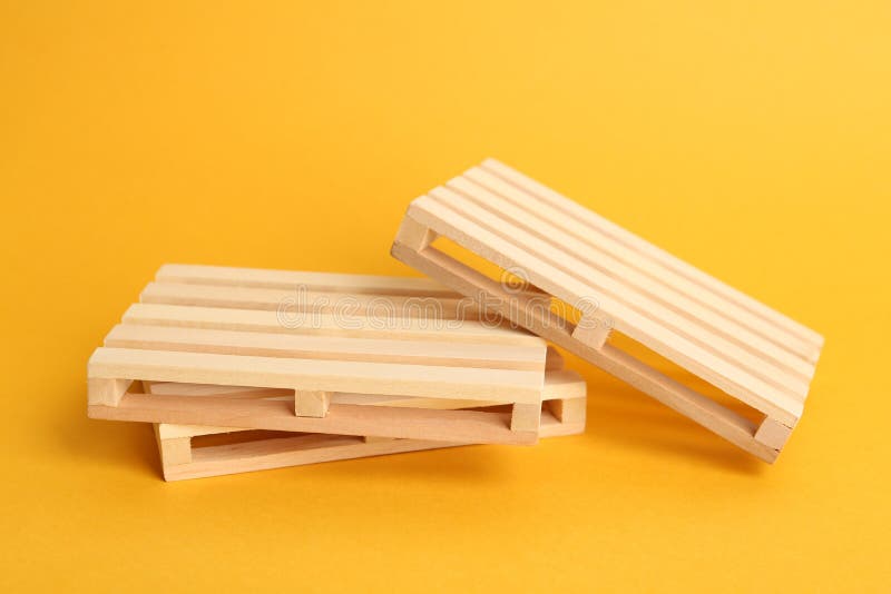 Three Small Wooden Pallets on Orange Background Stock Photo - Image of ...
