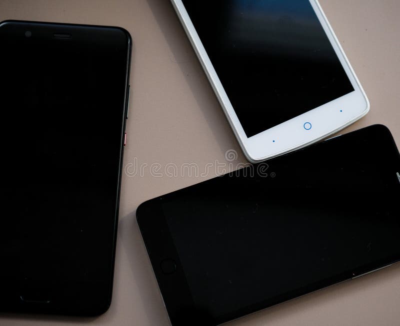 Three Smartphones on a Desk Stock Photo - Image of modern, table: 165381180