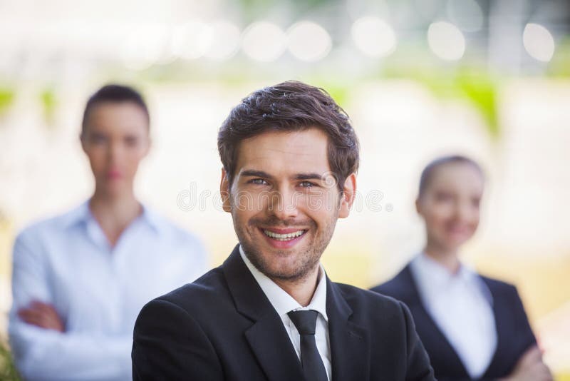 Three Smiling Business People Standing Outside. Stock Photo - Image of ...