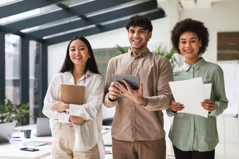 Three Smiling Multicultural Colleagues Standing Posing in Office ...