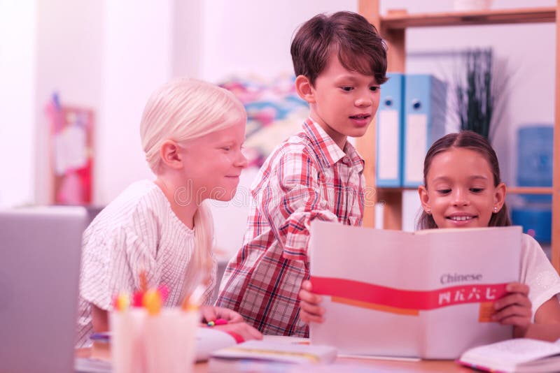 Three Smiling Pupils Learning Chinese in the Classroom. Stock Image ...