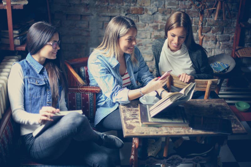 Three Students Girl Using Mobile in Library. Stock Image - Image of ...