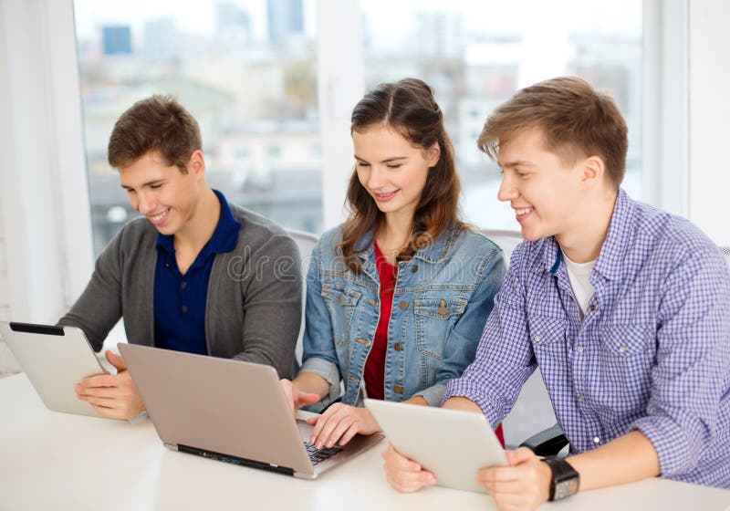 Three Smiling Students with Laptop and Tablet Pc Stock Photo - Image of ...
