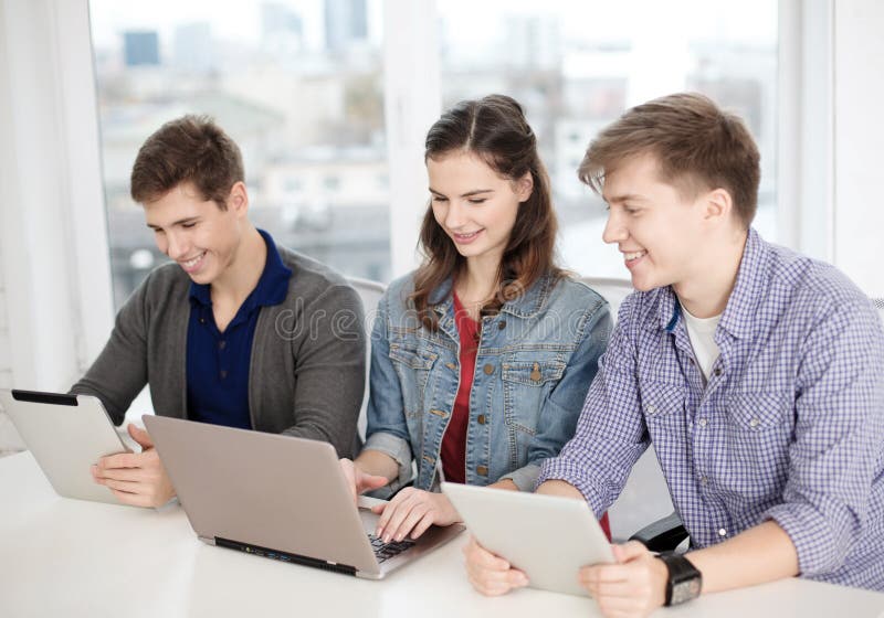 Three Smiling Students with Laptop and Tablet Pc Stock Image - Image of ...