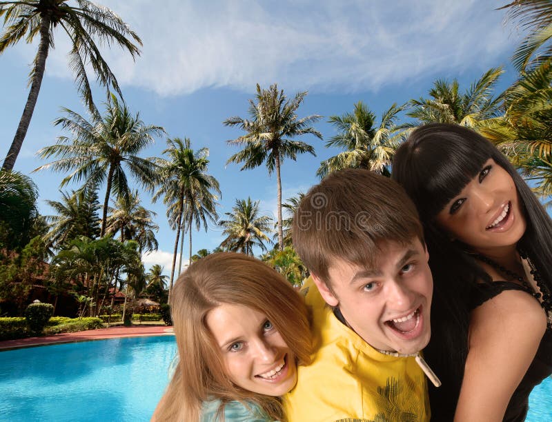 Three smiling young people stock photo. Image of bali - 4963394
