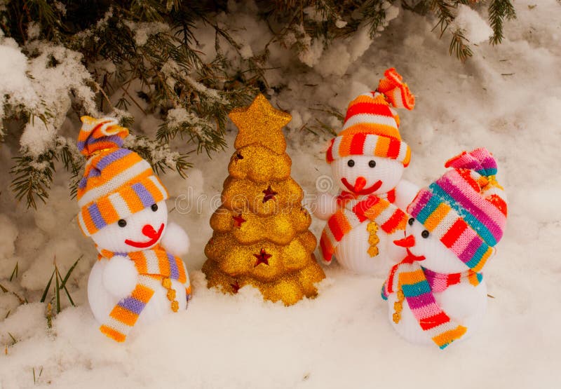 Three Snowmen with Golden Evergreen Tree Stock Image - Image of smiling ...
