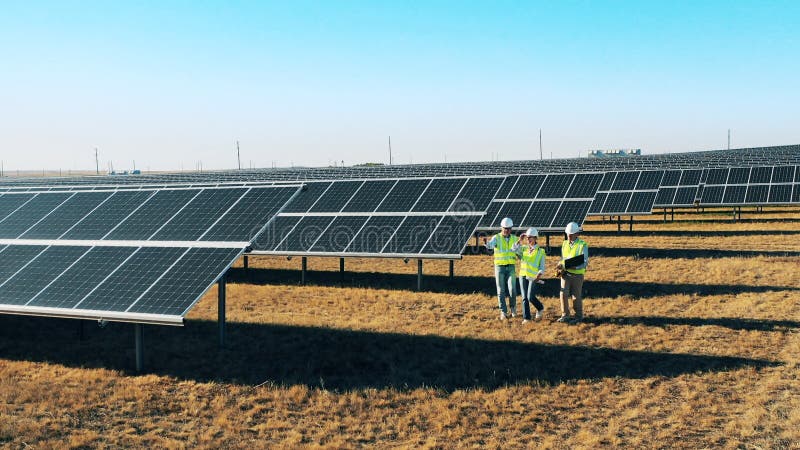 Three Solar Power Engineers Having a Discussion in at a Solar Power ...
