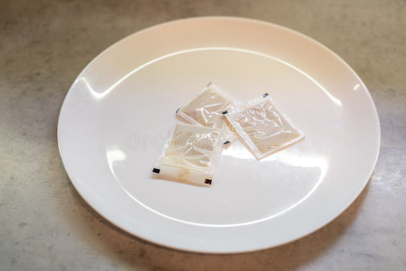 Three Spice Packets Placed White Plate. Each Sealed, Contents Concealed ...