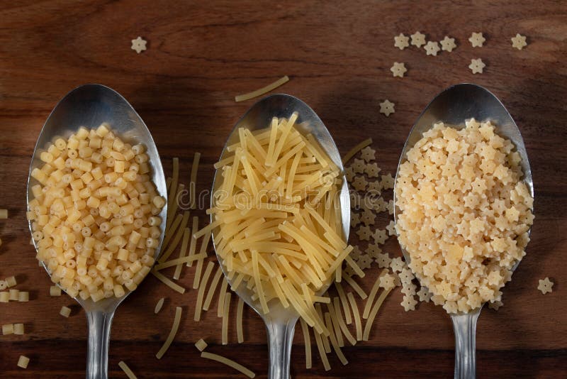 Three Spoons Lie Next To Each Other on a Wooden Table. Each Spoon Has a ...