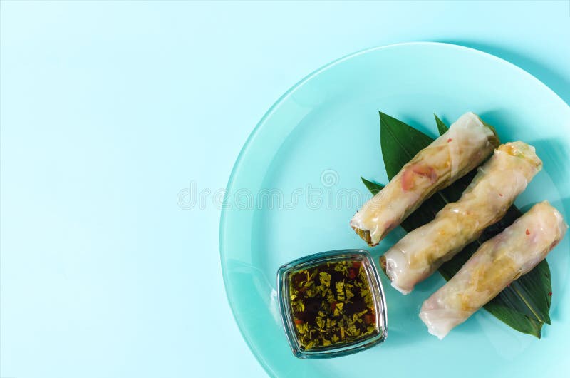 Three Spring Rolls Stuffed with Seafood and Vegetables on a Light Plate ...
