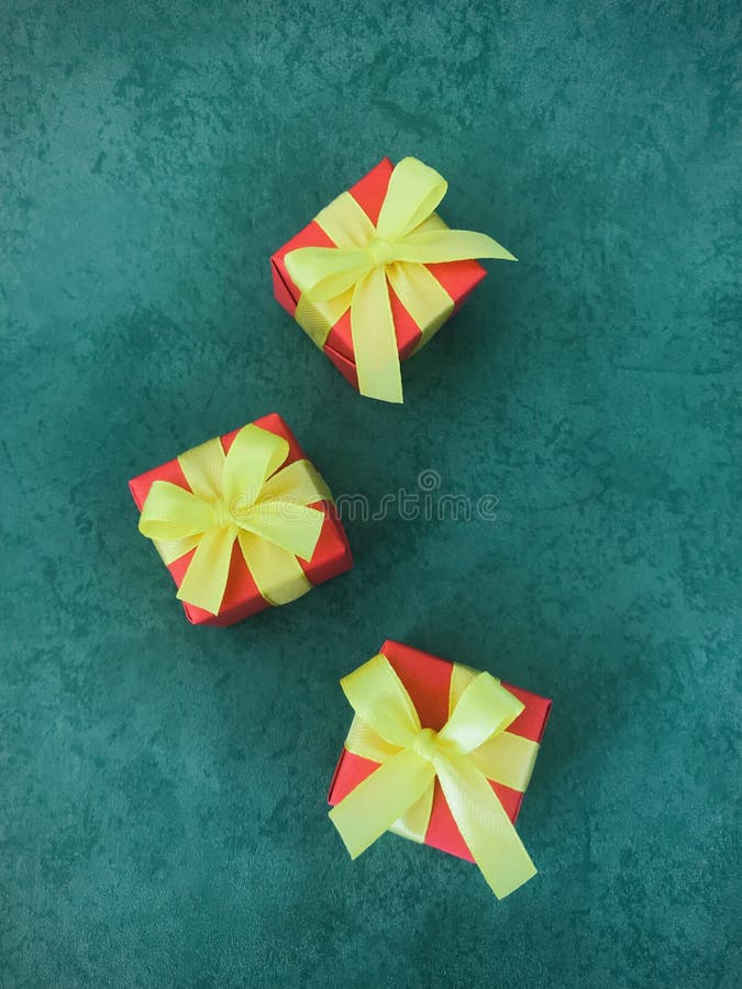 Three Square Red, Green and Yellow Gift Boxes Arranged in a Triangle on ...