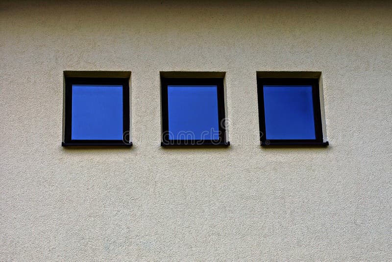 Three Square Small Windows on the Gray Wall of the Building Stock Image ...