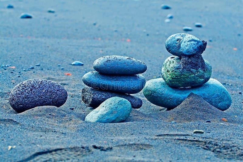 Three Stacked Balanced Stones or Pebbles on Black Volcanic Sand Stock ...