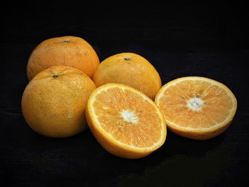 Three Oranges, One Orange Cut Open and Sitting on Top of Each Other ...
