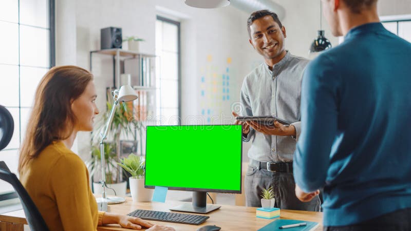 Three Start-up Entrepreneurs Work on Desktop Computer with Green Mock ...