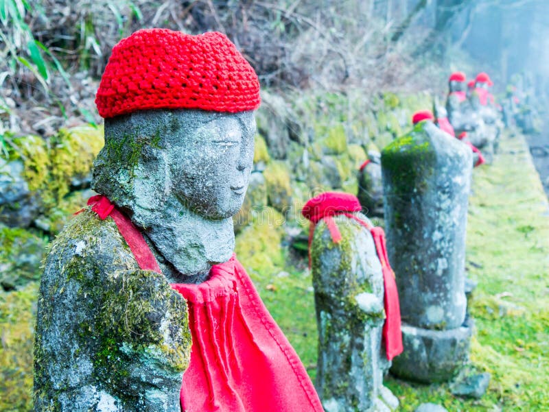 Three Statues with Red Scarf on in a Field of Grass Stock Image - Image ...