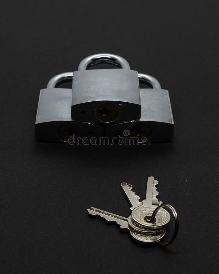 Three Steel Padlocks and Keys on Black Surface Stock Photo - Image of ...