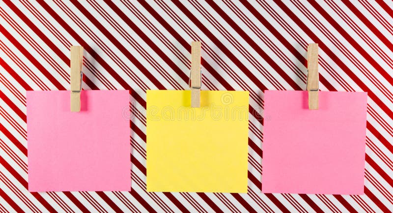 Three Sticky Notes with Clothespins on Stripped Background Stock Image ...
