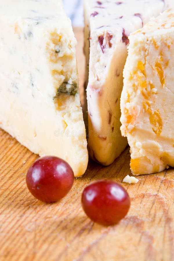 Three stiltons with grapes stock photo. Image of food - 4704376