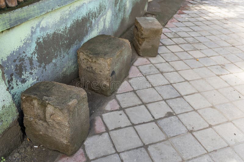 Three Stone Blocks are Sitting on a Brick Sidewalk Stock Photo - Image ...