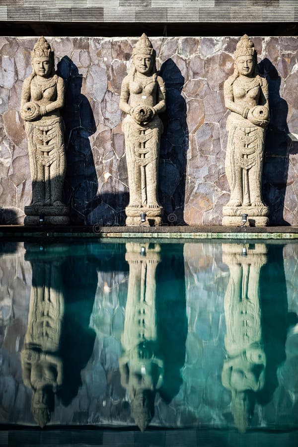 Three Stone Statues in the Shape of Women by the Pool Stock Image ...