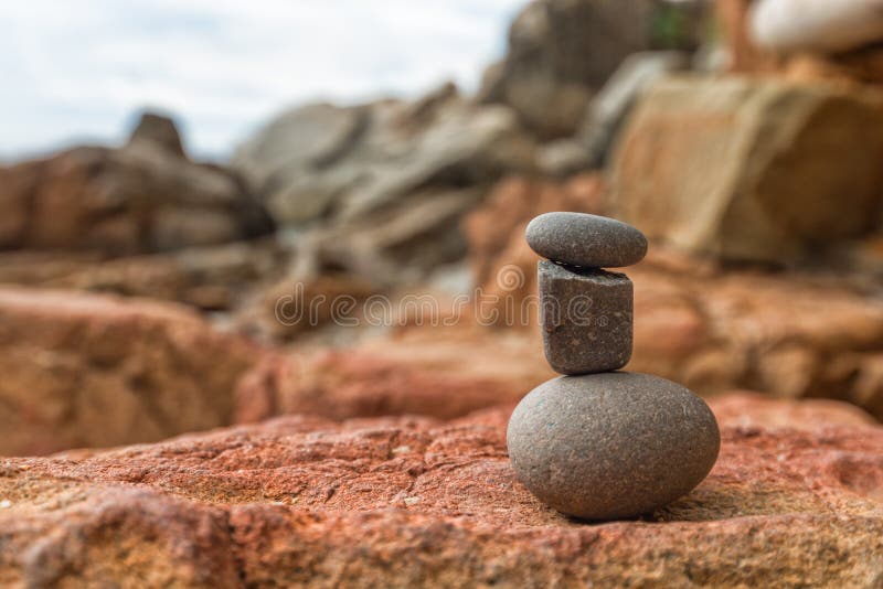 Three Stones in a Stack Near the Sea on the Beach. Ideological Concept ...