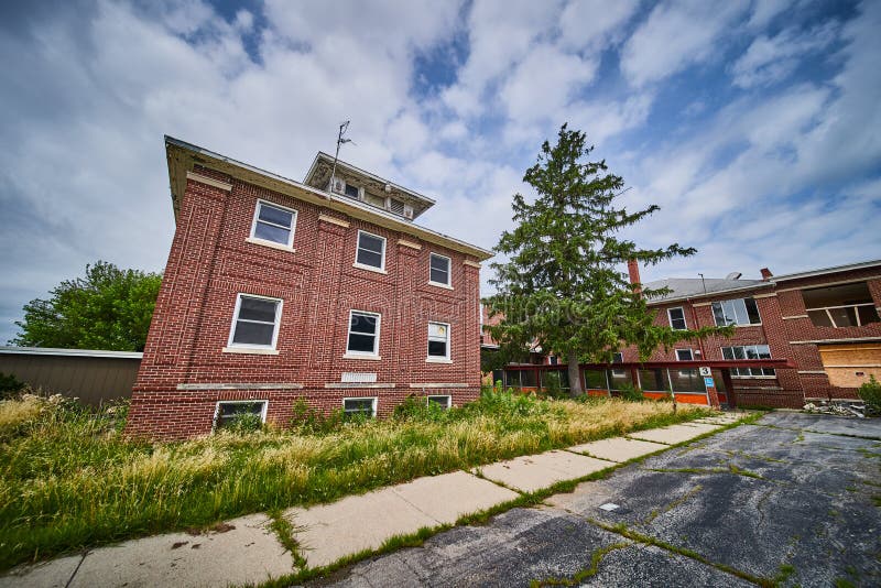 Three Story Abandoned Brick Building from Exterior Parking Lot with ...